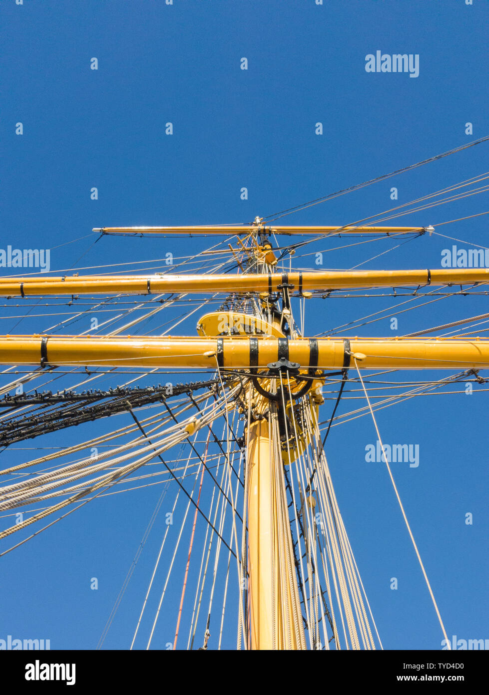 Yellow metal masts and the yards of the sailing ship Stock Photo - Alamy