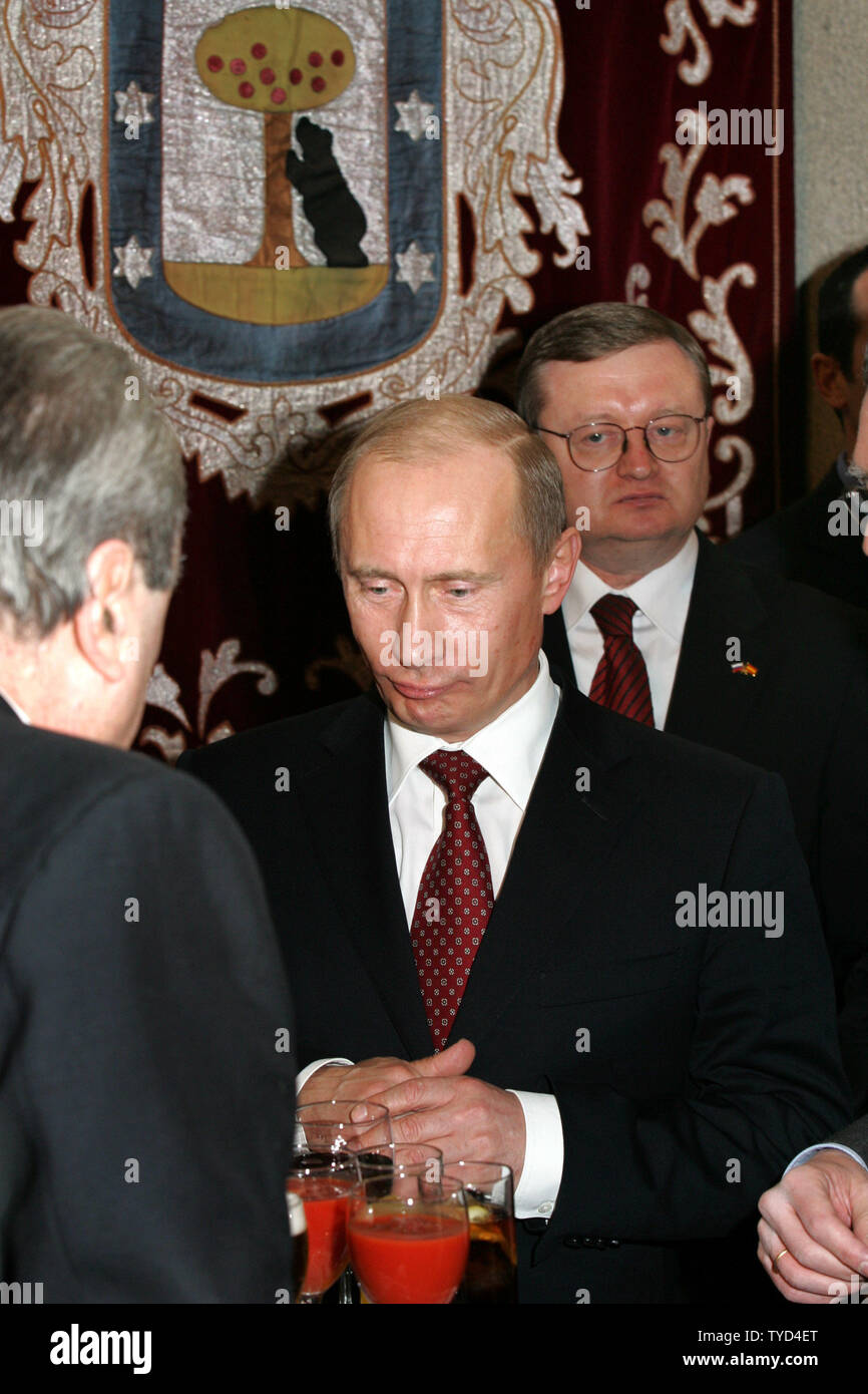 Russian President Vladimir Putin (C) takes a glass of juice at Royal ...