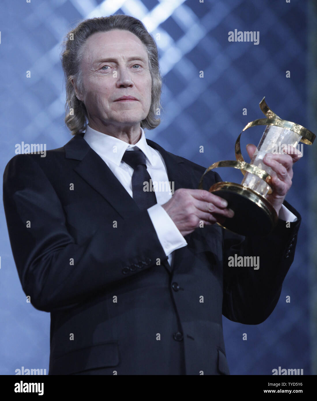 Actor Christopher Walken holds an award given to him during a tribute ...