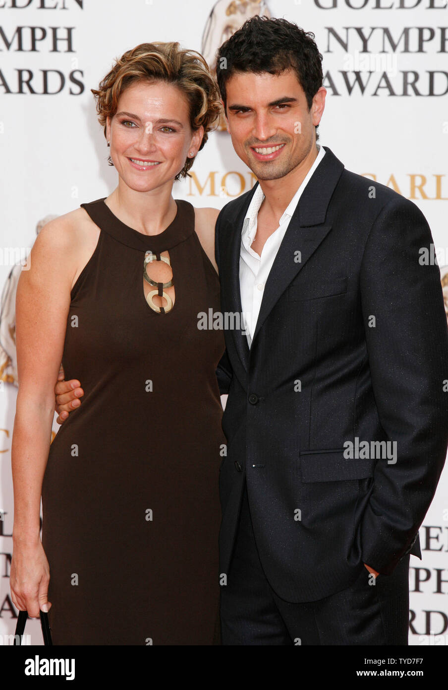 Actor Stephane Metzger (R) and guest Aurelie arrive on the red carpet ...