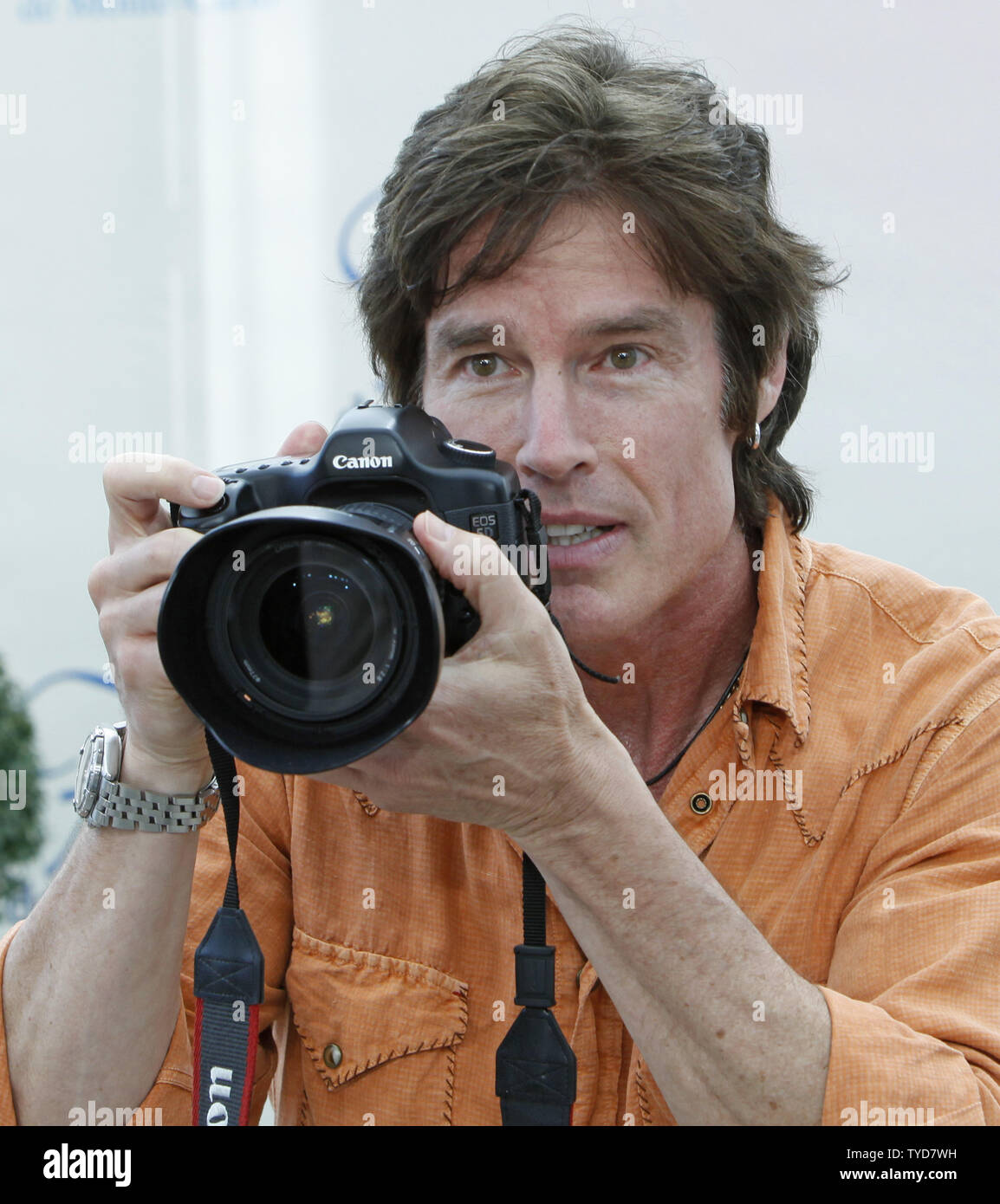 Actor Ronn Moss takes a photo of the photographers during a photocall ...