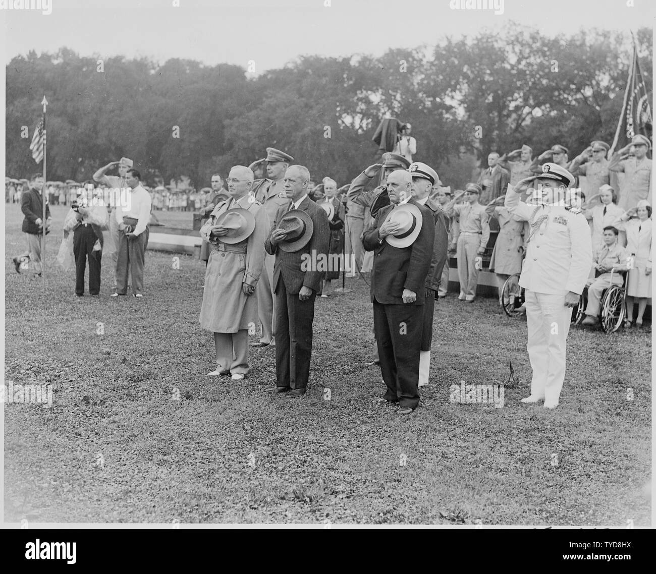 Photograph of President Truman and other dignitaries saluting during ...