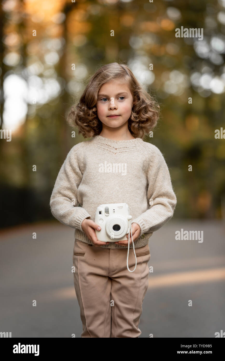 Stylish child girl 6-7 years old wearing designer blue velvet dress in ...