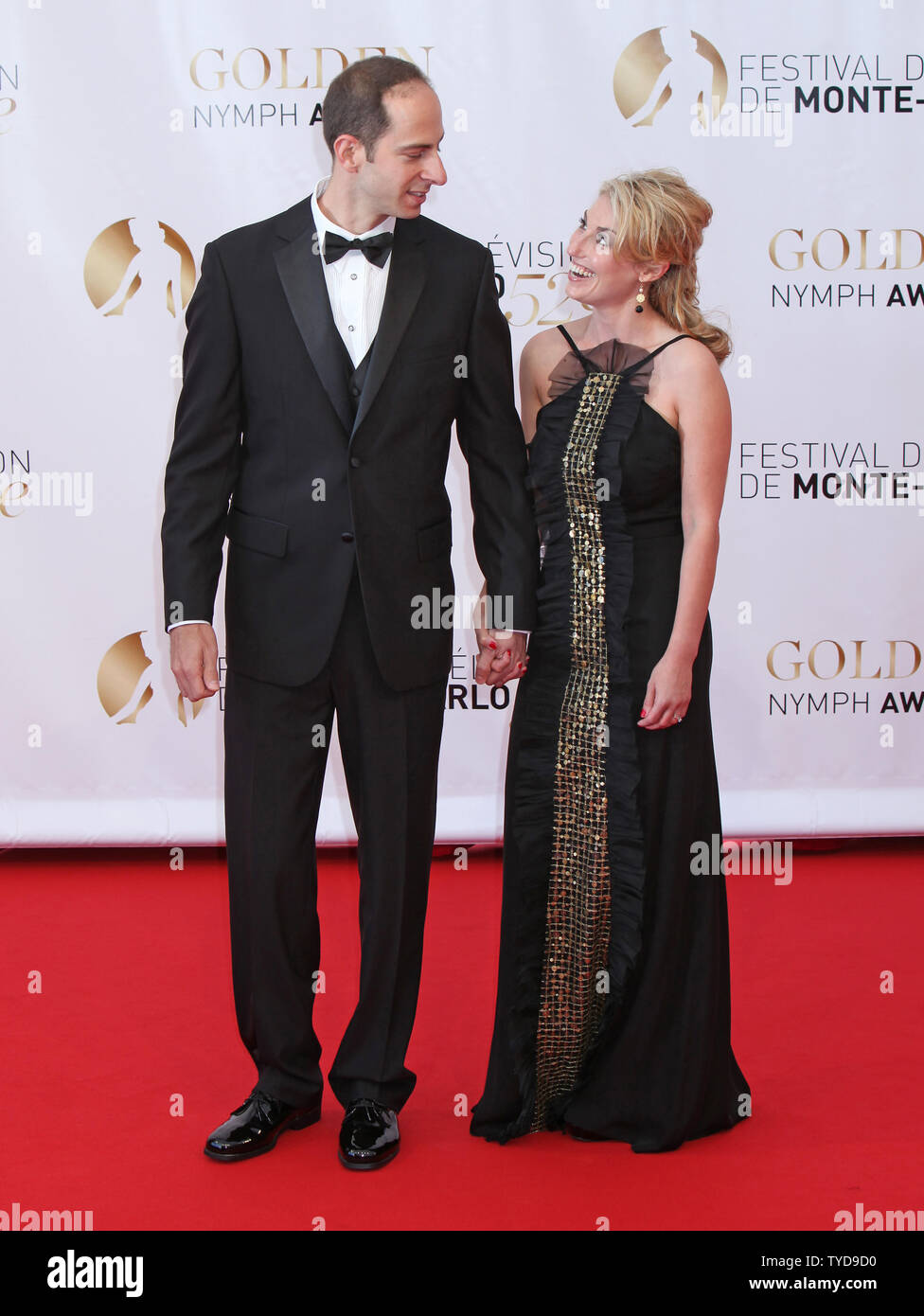 Ernie Grumwald and guest arrive on the red carpet for the closing ...