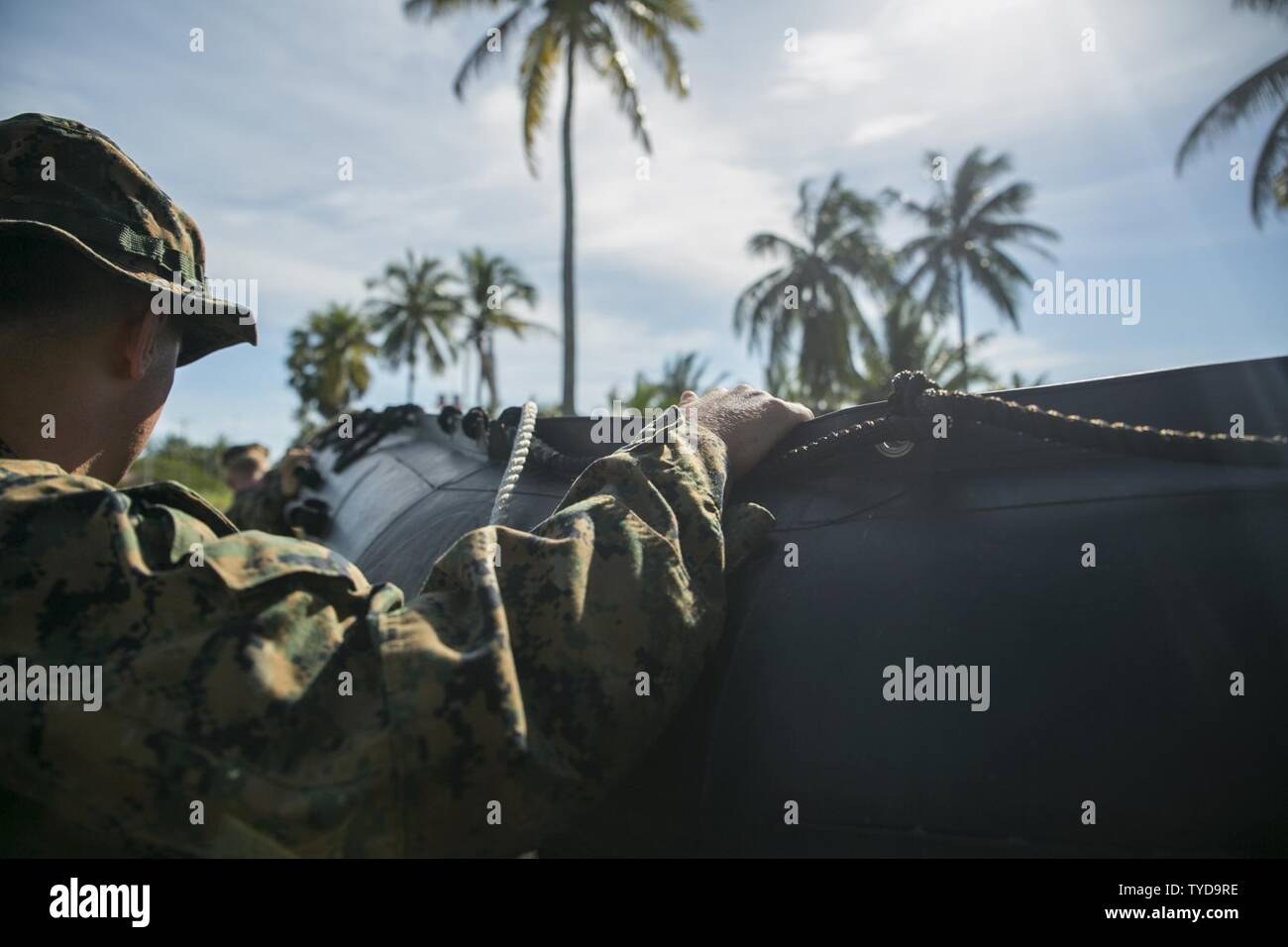 U.S. Marines secure a Combat Rubber Reconnaissance Craft (CRRC) onto a ...