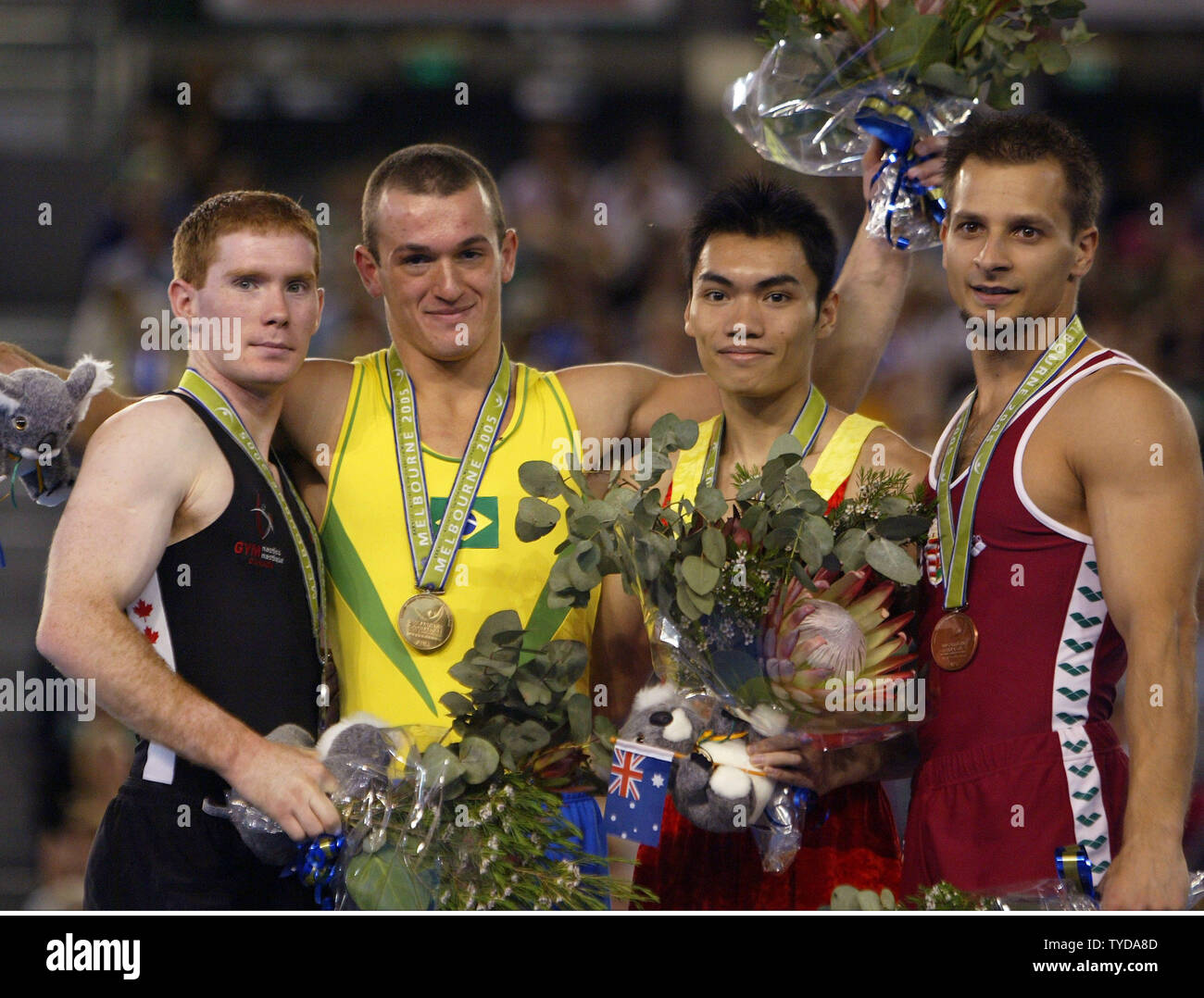 Medalists in the men's floor exercise finals brandish their medals at ...