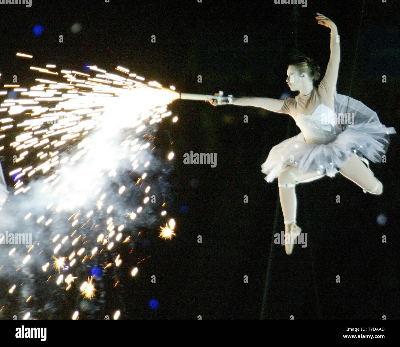 An aerial dancer releases a shower of pyrotechnic stars over the ...
