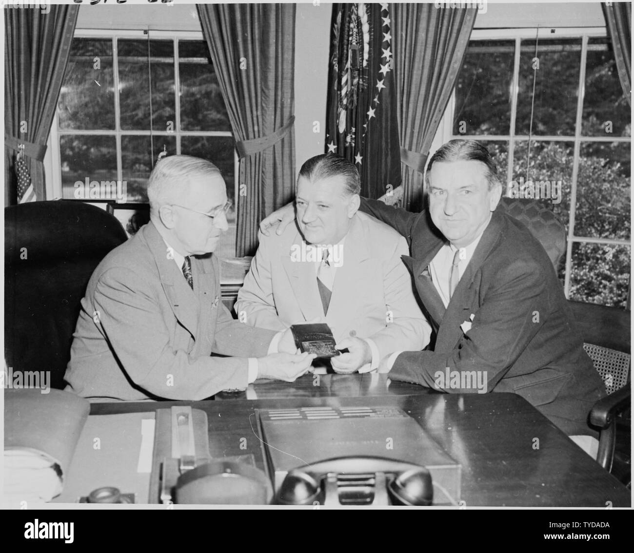 Photograph of President Truman at his desk in the Oval Office ...