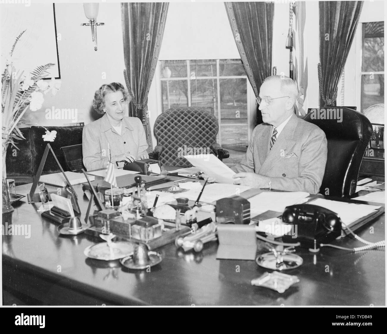 Photograph of President Truman at work at his desk in the Oval Office ...