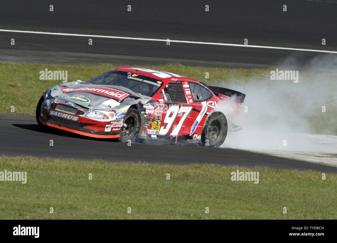 Kurt Busch brings his heavely damaged race car into the pits in the ...