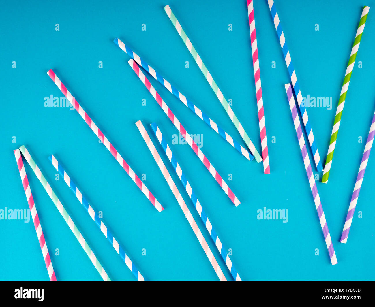 Background of Striped drink straws in different colors on blue ...