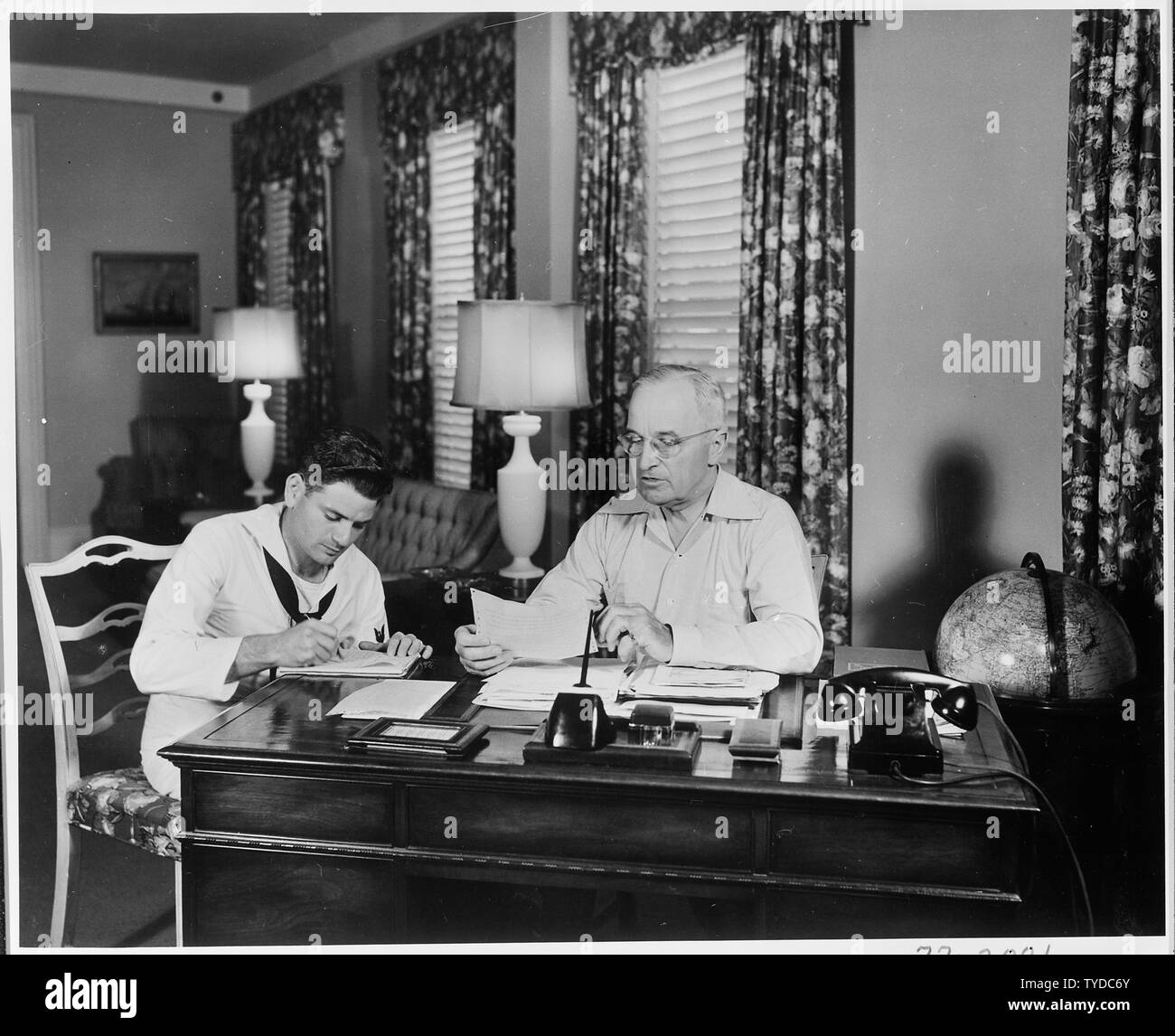 Photograph of President Truman dictating to Navy Yeoman Emil Kesselman ...