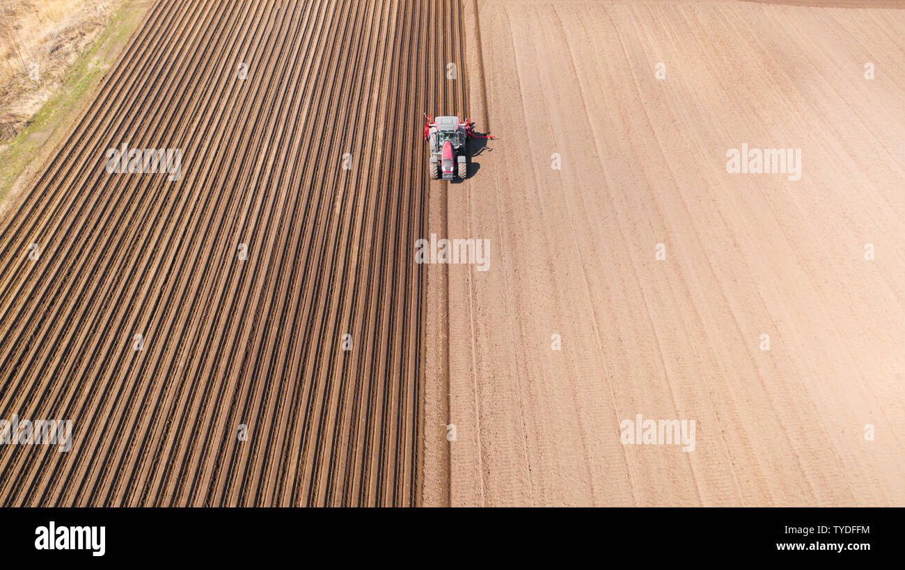 Tractor on a plowed field, top view. Agricultural field for planting ...