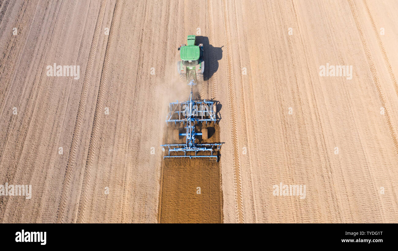Tractor plows the field, top view. The agricultural field is prepared ...