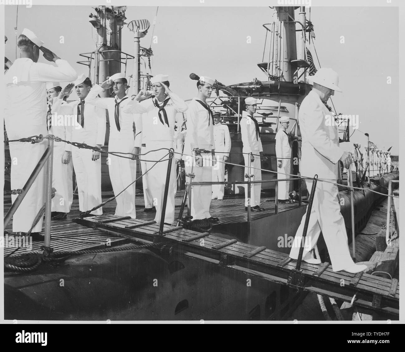 Photograph of President Truman receiving the salute of the crew as he ...