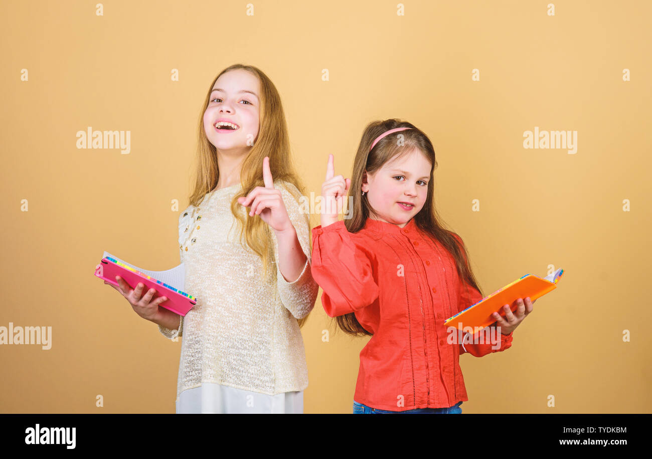 Really busy. students reading a book. School project. small girls with ...