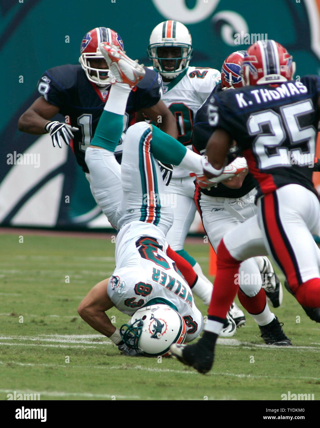 Miami Dolphins wide receiver Wes Welker is knocked head over heals on ...