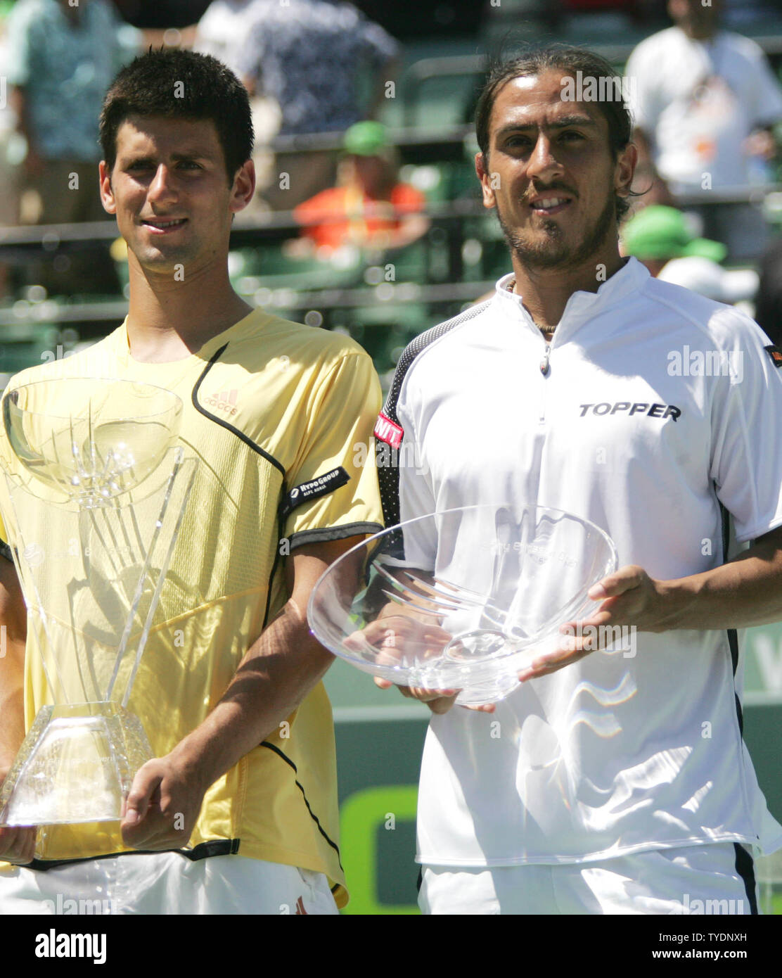 Novak Djokovic and Guillermo Canas hold their championship trophies at ...