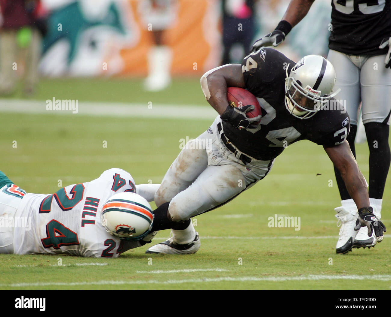 Oakland Raiders running back LaMont Jordan is stopped by Dolphins ...