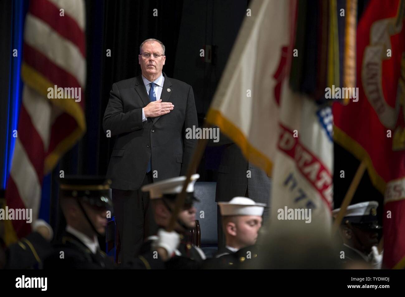 Deputy Defense Secretary Bob Work places his hand over his heart while ...