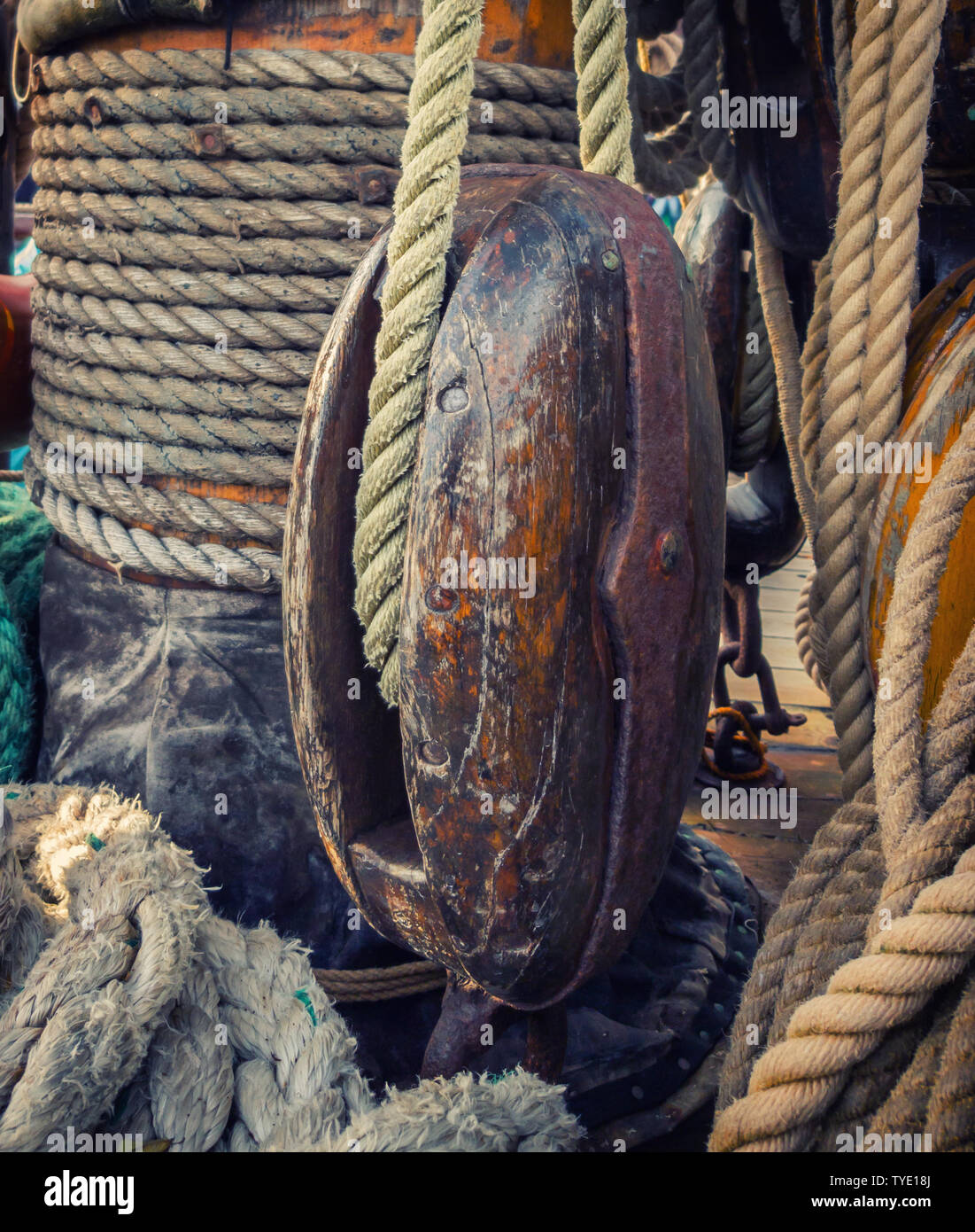 Wooden block and ropes on the background of the mast of the sailing ...