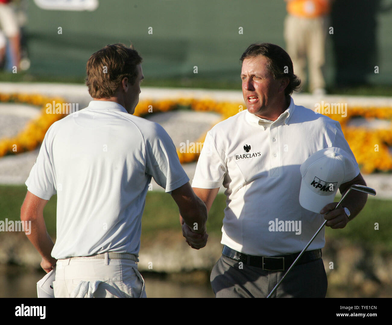 Phil Mickelson (R) shakes hands with Nick Watney after beating him by ...