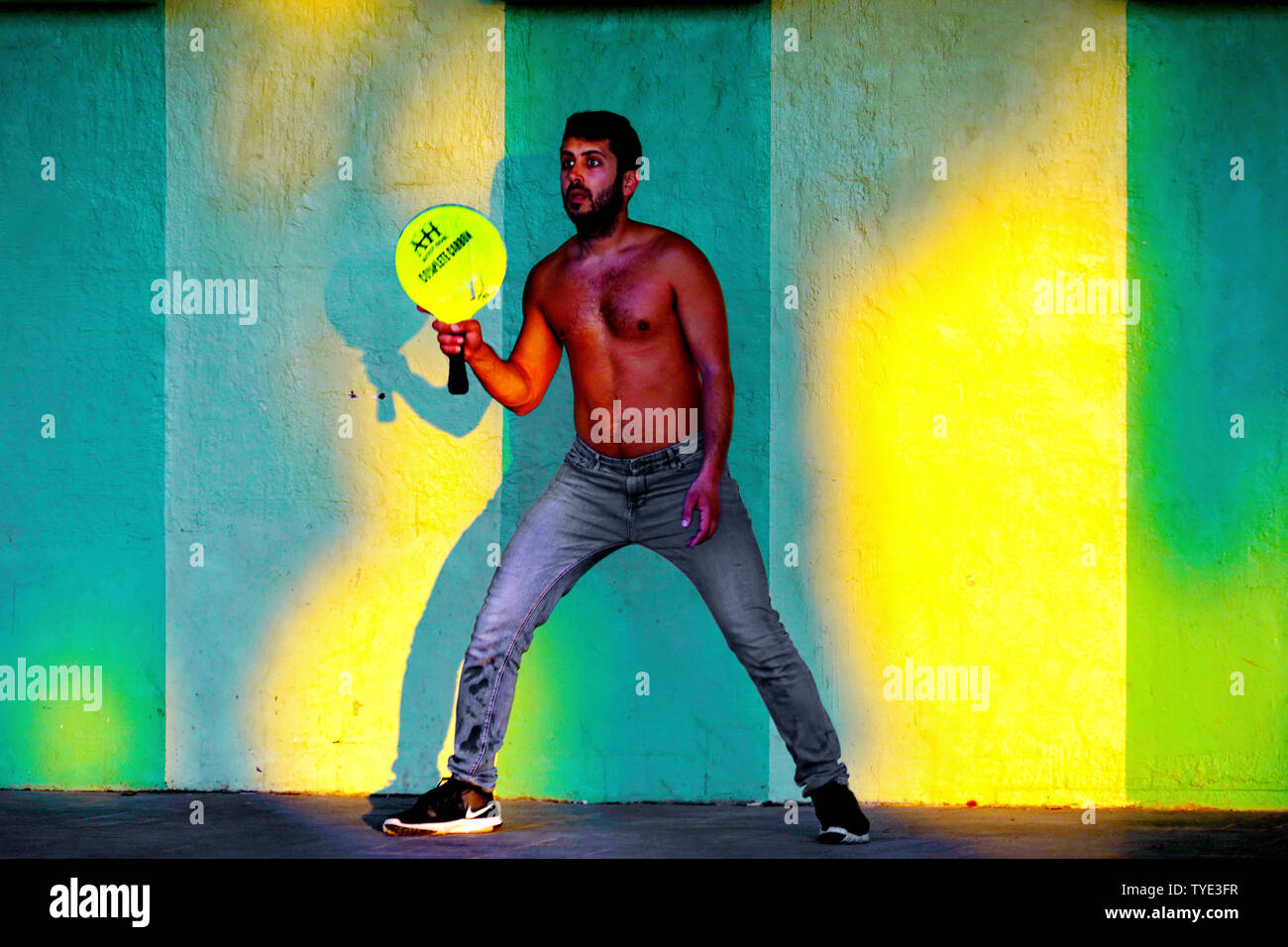 Two young men playing with a paddle and rubber ball AKA Matkot on the ...