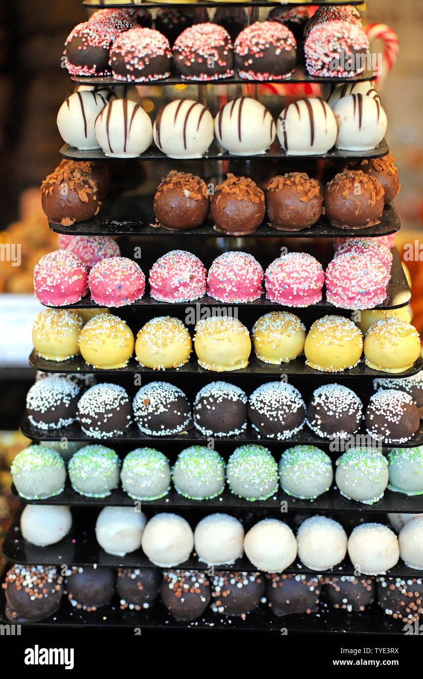 Tower or pyramid and cupcakes on sweet dessert table. Sweets in various ...