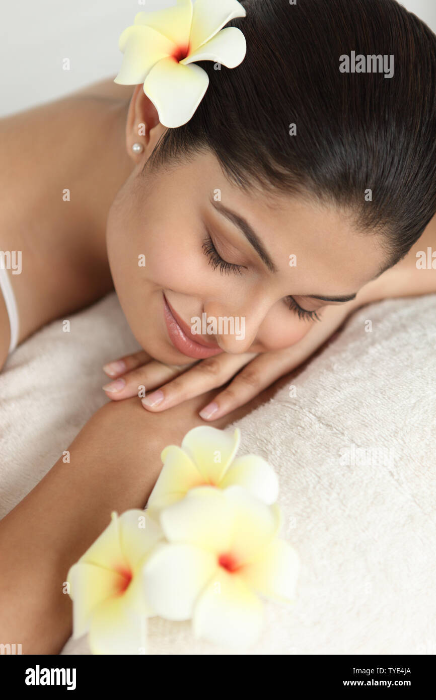 Indian young woman relaxing on a massage table Stock Photo - Alamy