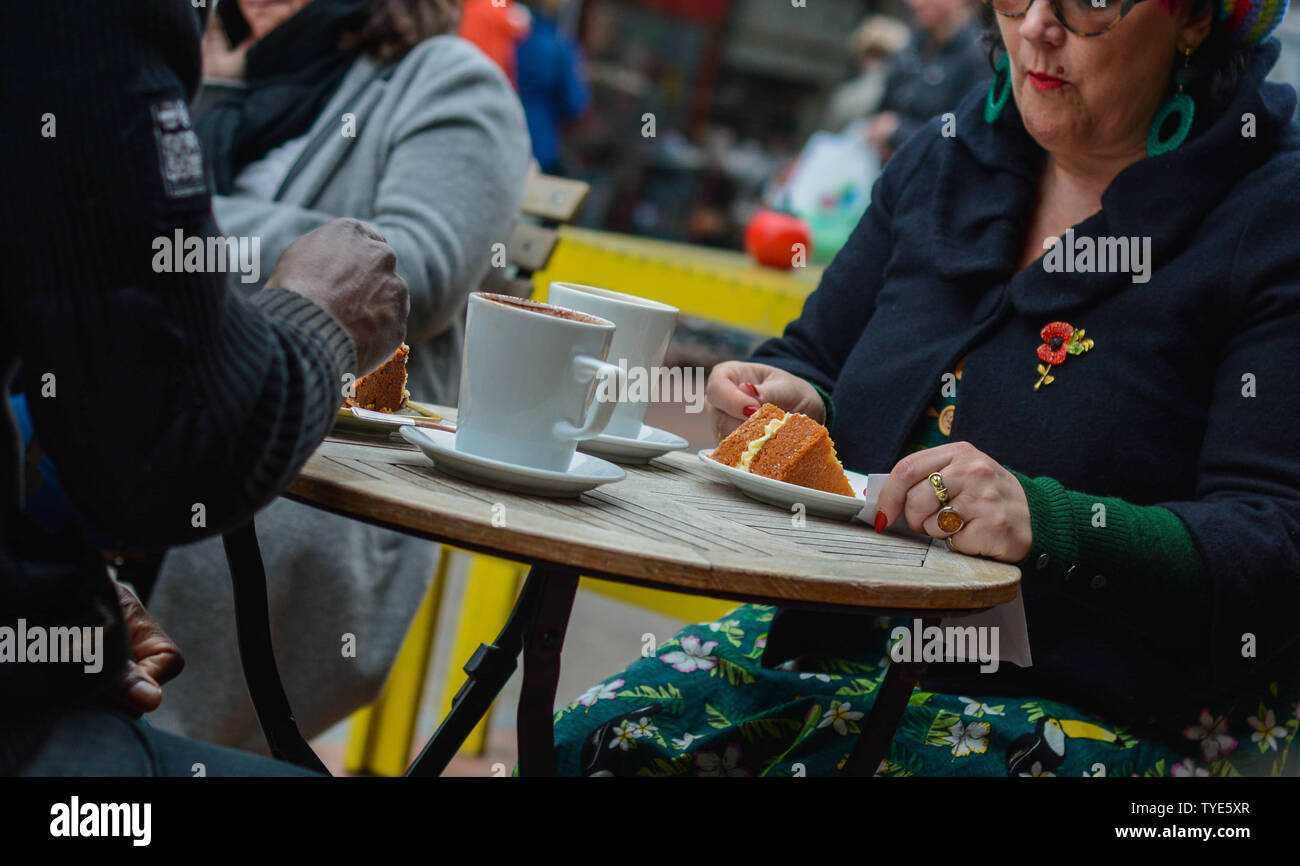 Middle age woman enjoying a cake at the terrace of a cafe Stock Photo ...