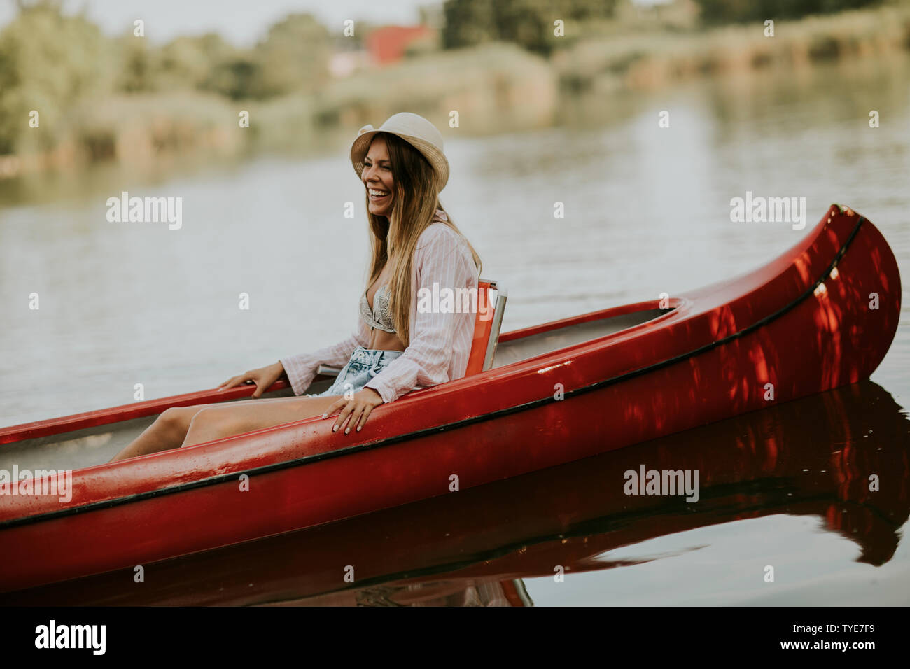 Pretty young woman in the canoe on the lake at summer day Stock Photo ...