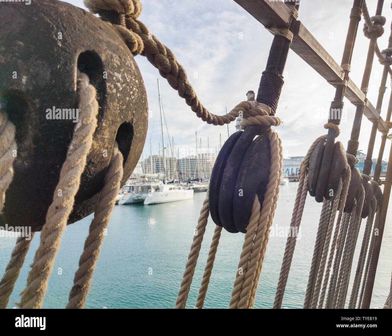 Old wooden deadeye on the shrouds of a sailing vessel of the eighteenth ...