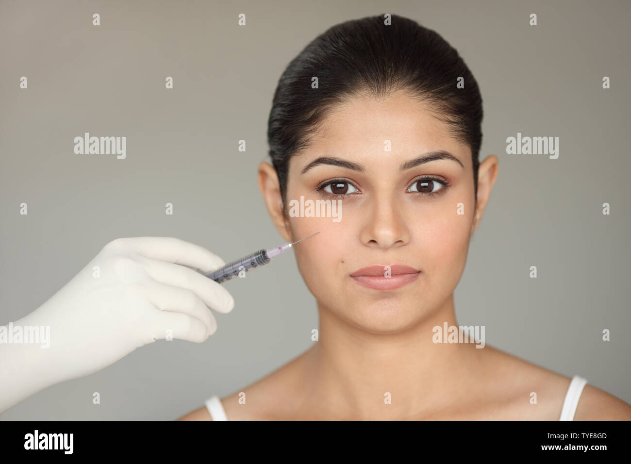 Woman receiving Botox injection in cheek Stock Photo - Alamy