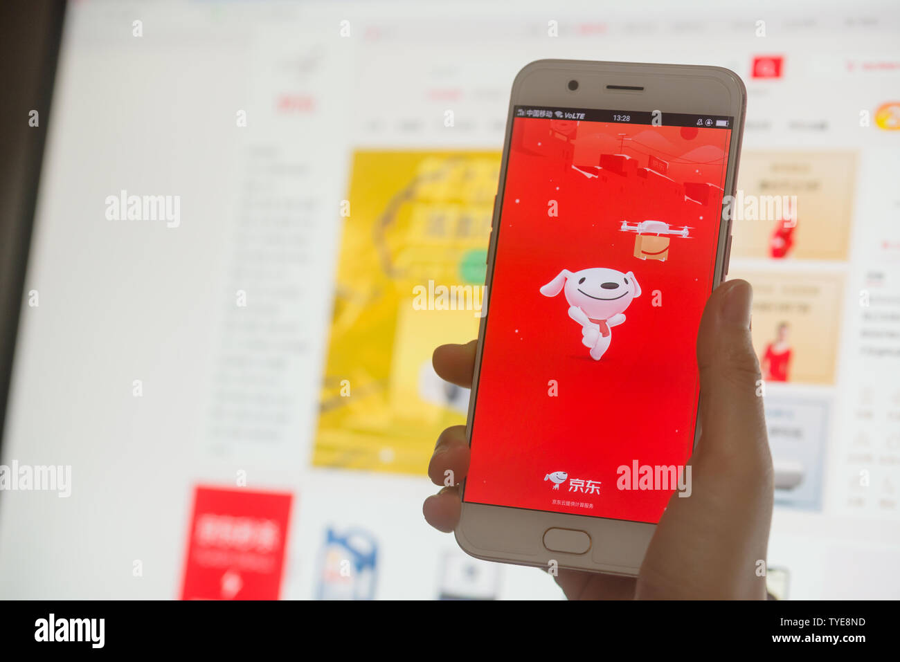 Close-up hand holding mobile phone login to JD APP client, imaginary ...