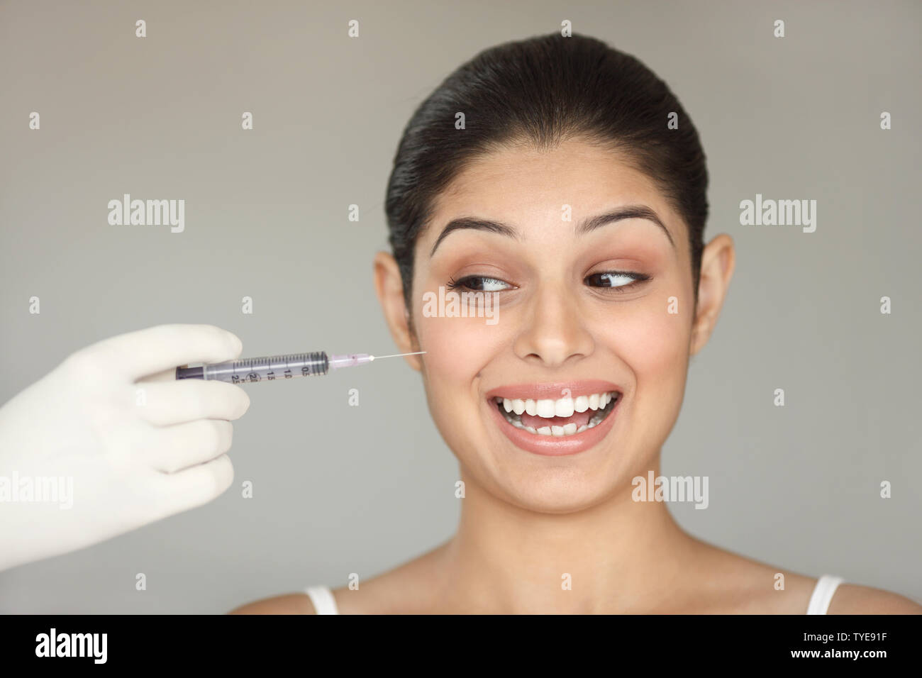 Woman receiving Botox injection in cheek Stock Photo - Alamy