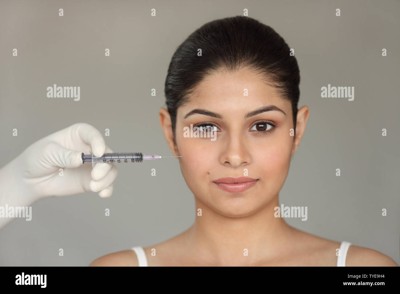 Woman receiving Botox injection in cheek Stock Photo - Alamy