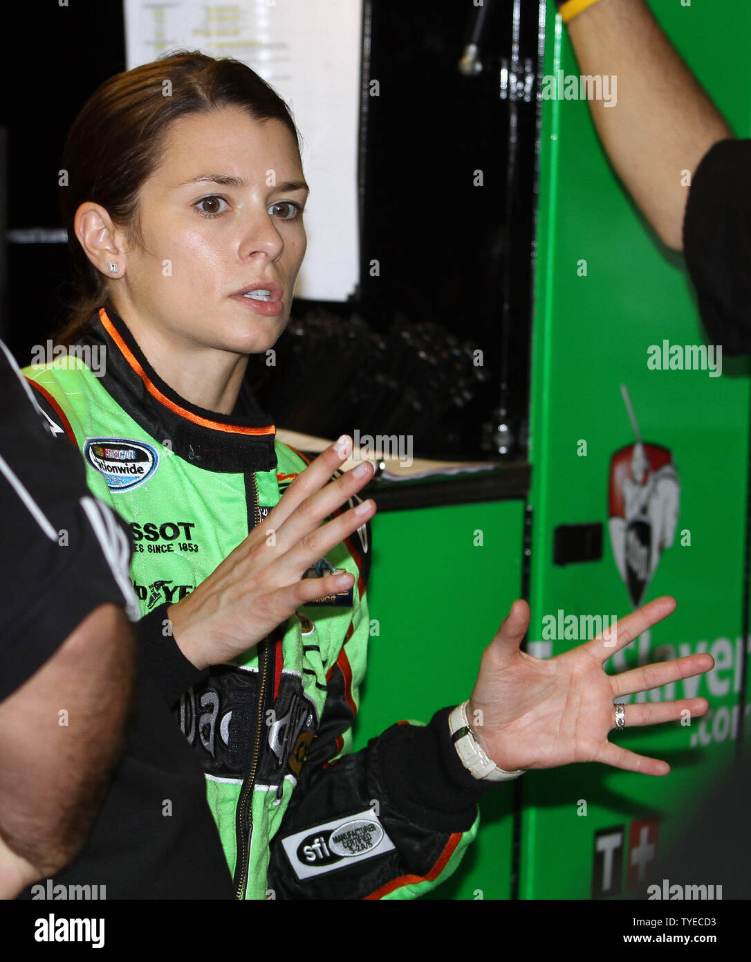 Danica Patrick waits in her garage during a rain delay of pratice for ...