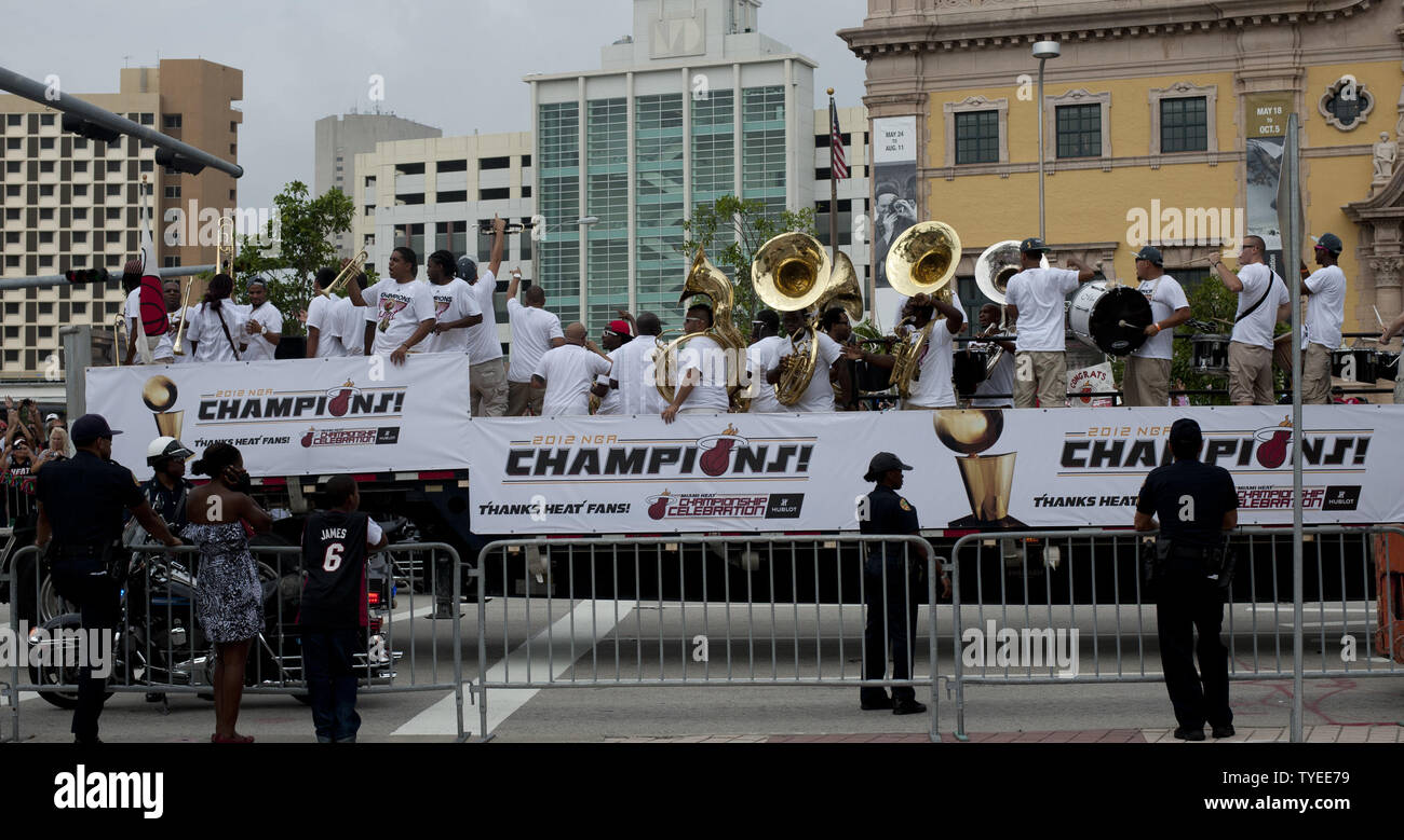 Miami Heat fans crowd the streets as the first of the Heat payer buses ...