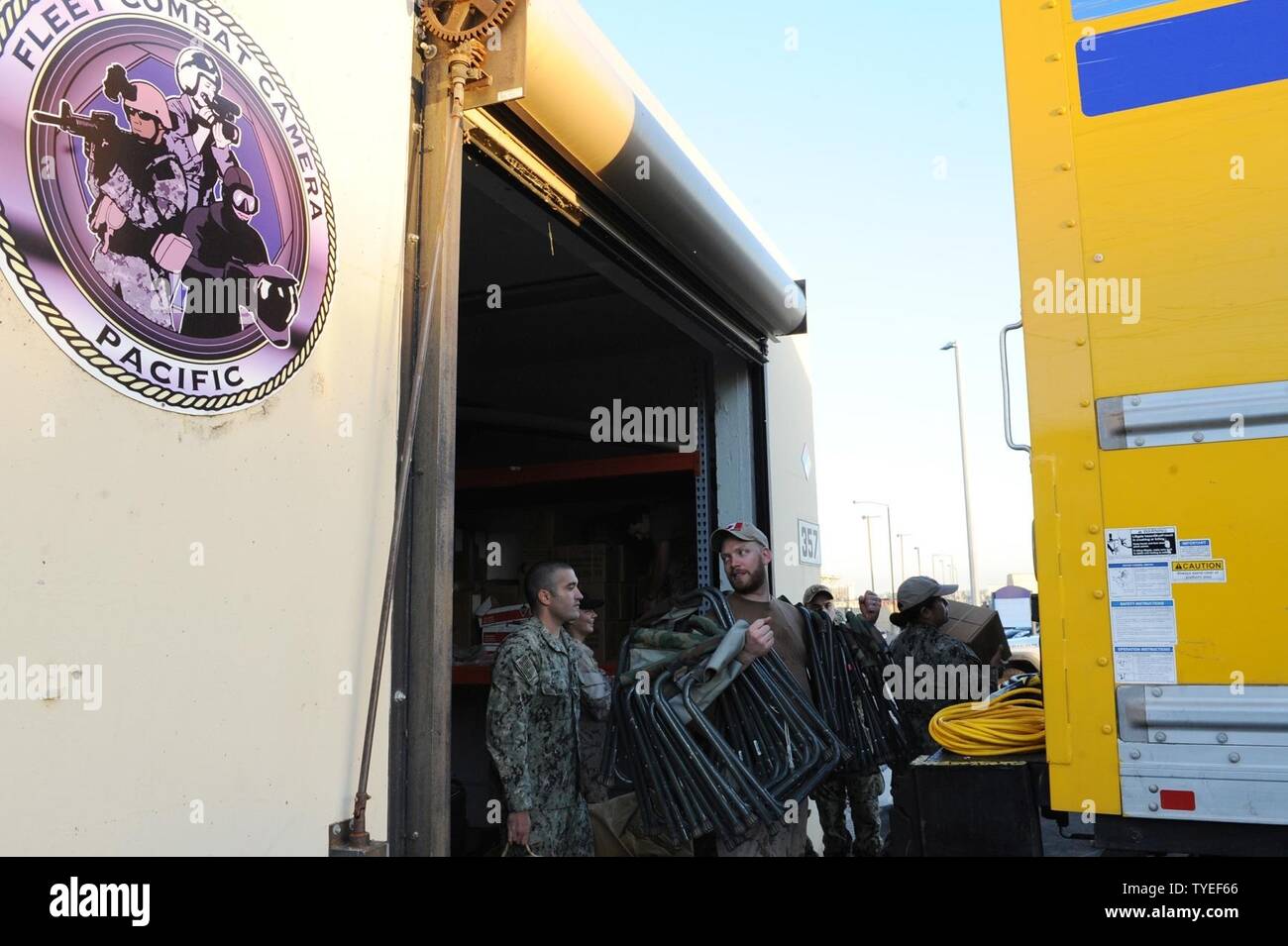 U.S. Navy Sailors and Canadian military forces load gear in preparation ...