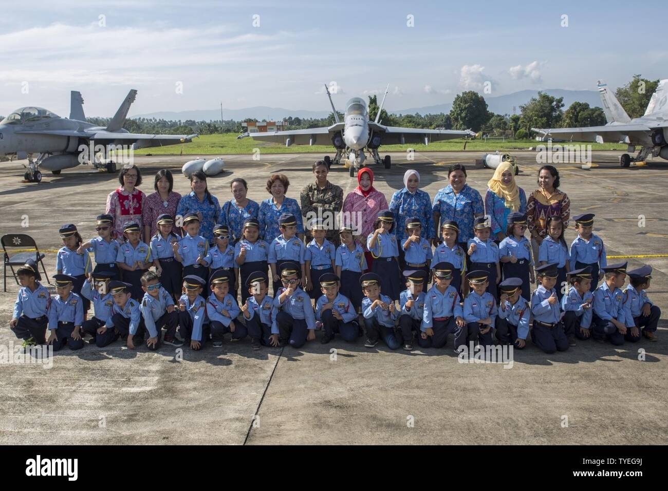 Indonesian locals and U.S. Marine Corps Lance Cpl. Chloe Stitt, an ...