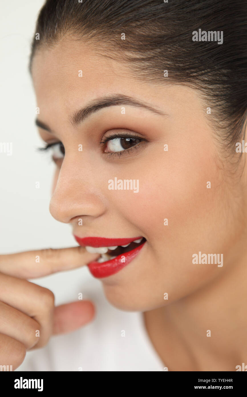 Close up of a girl with finger in her mouth hi-res stock photography ...