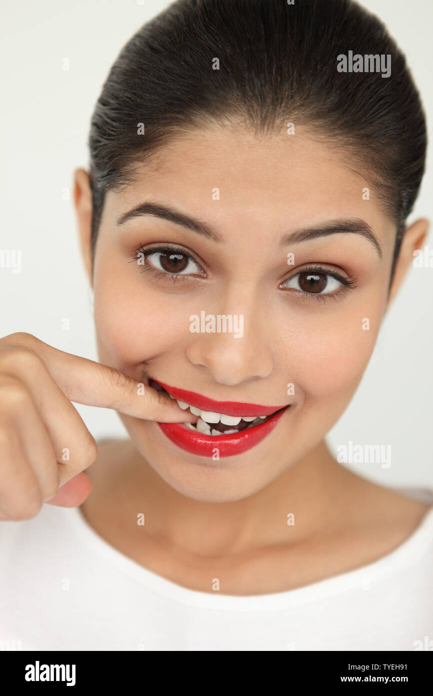 Portrait of a woman with her finger in mouth Stock Photo - Alamy