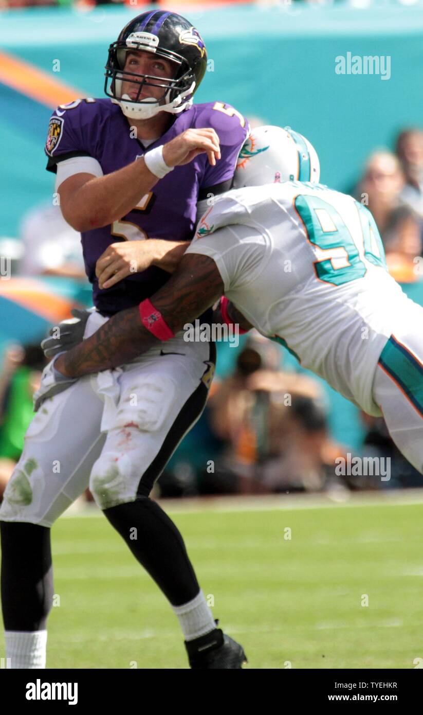 Baltimore Ravens QB Joe Flacco (5) takes a hit by Miami Dolphins LB ...