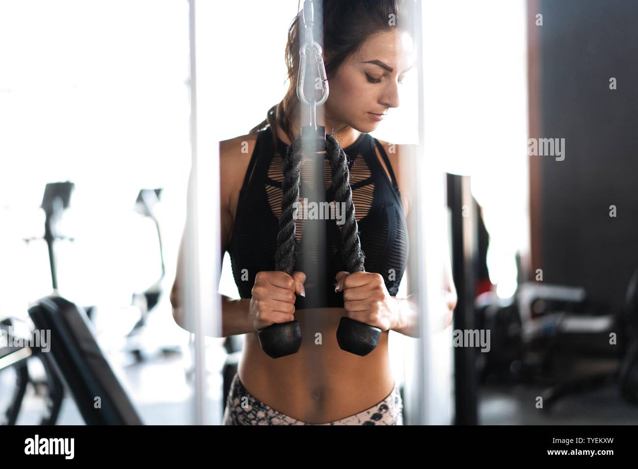 Attractive woman training in light modern gym. Beautiful muscular fit ...