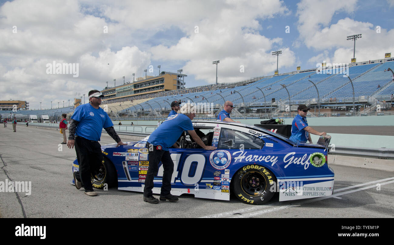 The crew for Landon Cassilli , 40, bring his car onto the track before ...