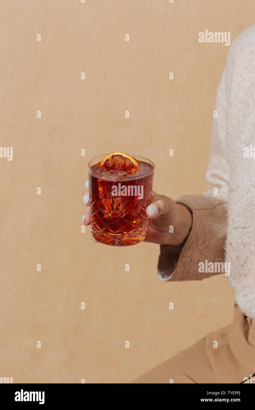 Woman helding Negroni, an italian cocktail, an apéritif, first mixed in ...