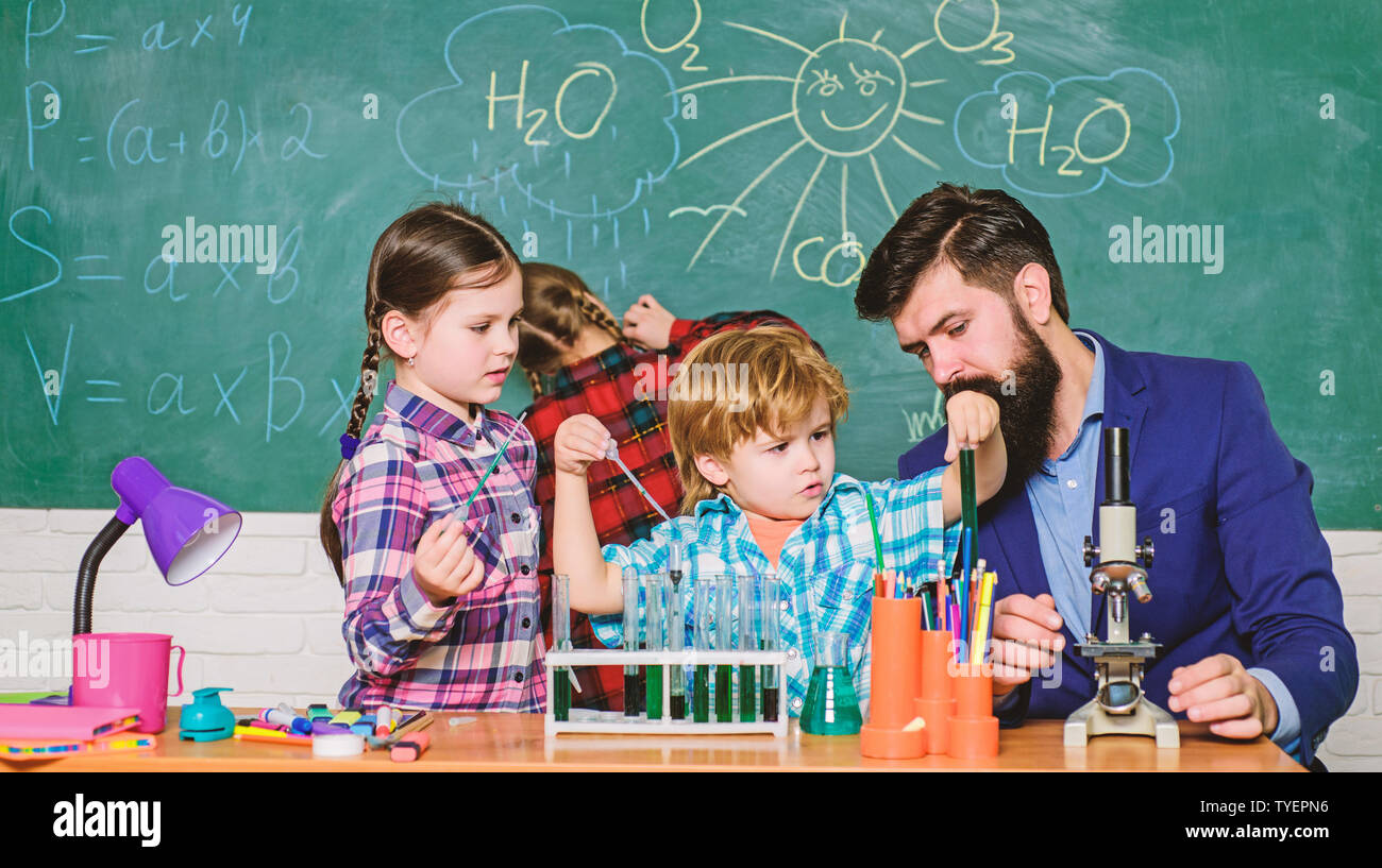 students doing science experiments with microscope in lab. school kids ...