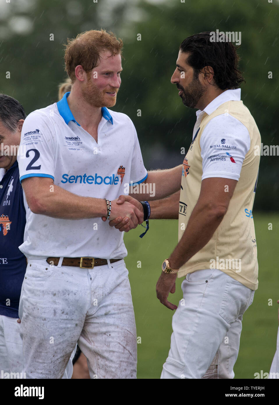 Britain's Prince Harry (L) shakes hands with Valiant team member Tommy ...