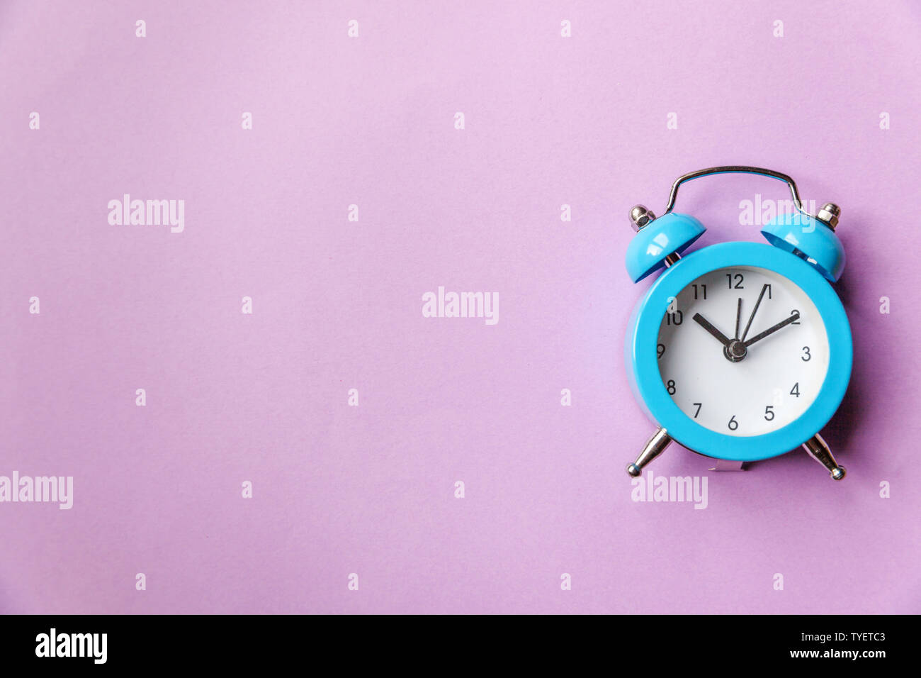 Ringing twin bell vintage classic alarm clock Isolated on purple violet ...