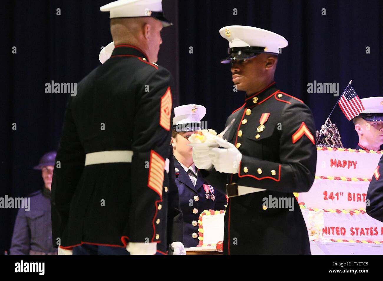 Pfc. Isaiah Living receives a slice of cake from Sgt. Maj. Benjamin ...